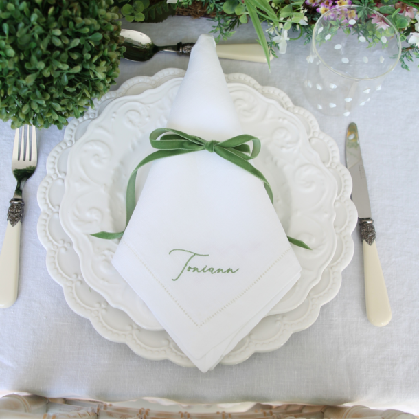 Elevating tables with napkins & bows | The Embroidered Napkin Co