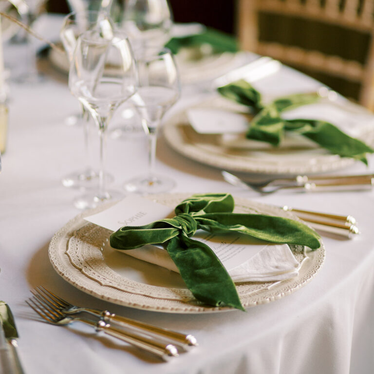Elevating tables with napkins & bows | The Embroidered Napkin Co
